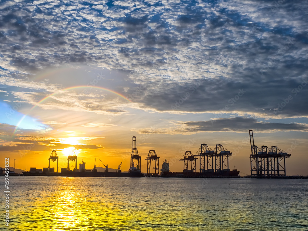 Containers loading by port crane in Silhouette at port of Thailand ...