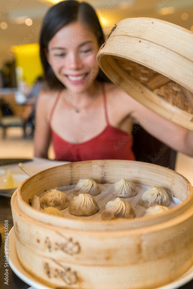 Asian woman eating typical shanghai chinese food xiao long bao soup ...