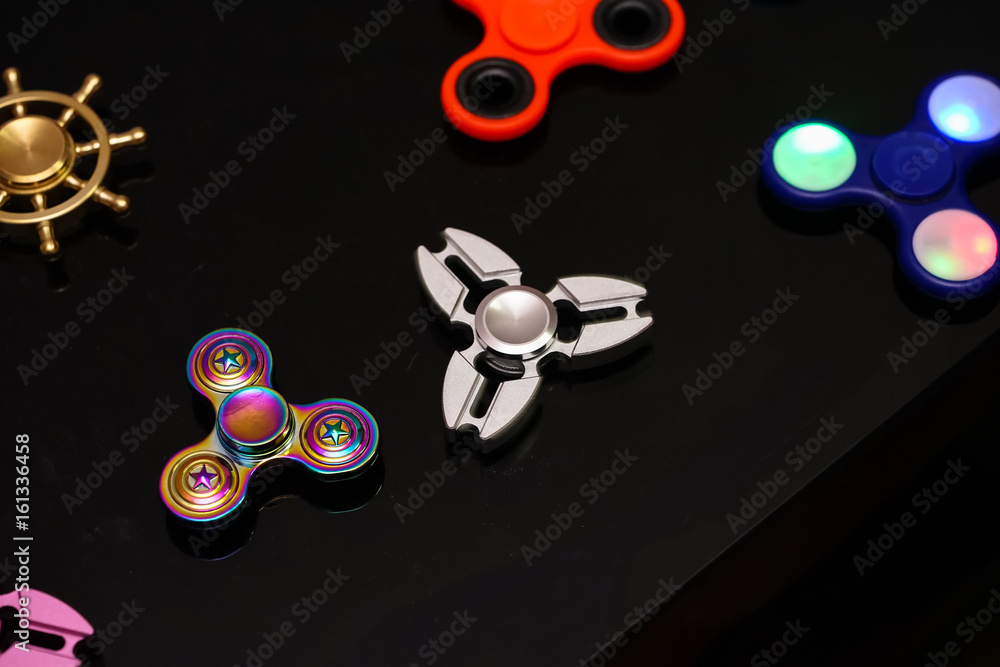 Hand spinners or fidgeting spinners. Many types and shapes of spinners ...
