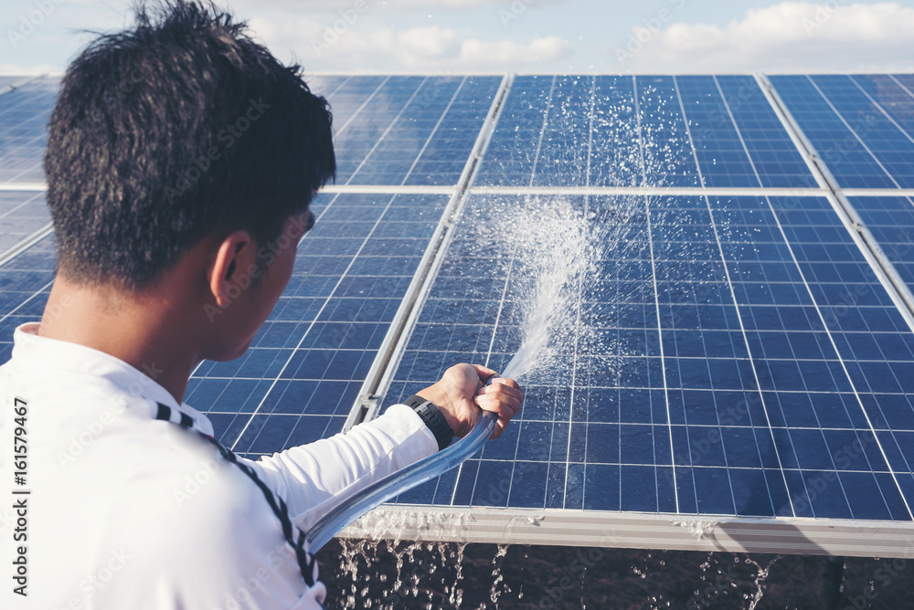 Workers or engineers are cleaning cleaning photovoltaic panels in the ...