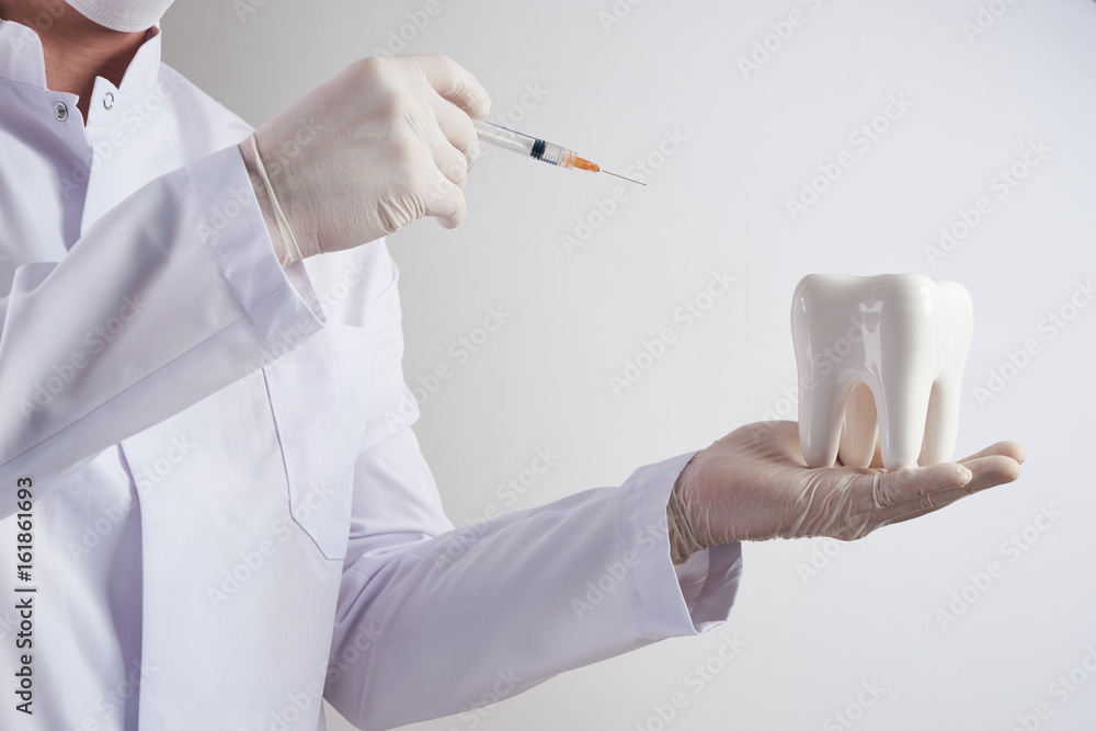 Dentist doing injection into the tooth in dental clinic. Dentist ...