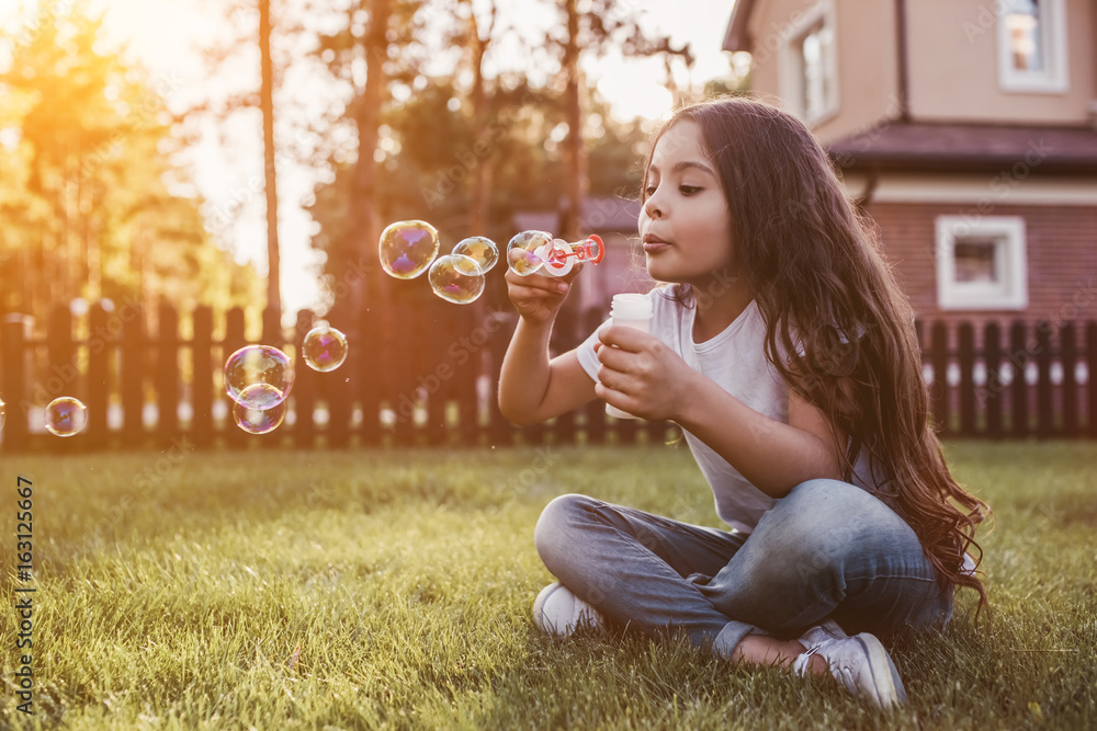 Little girl on backyard Stock Photo | Adobe Stock