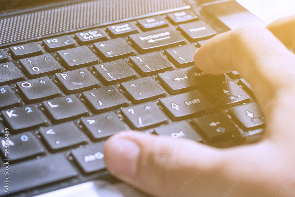 finger pointing on Enter button with lens flare, concept of getting ...