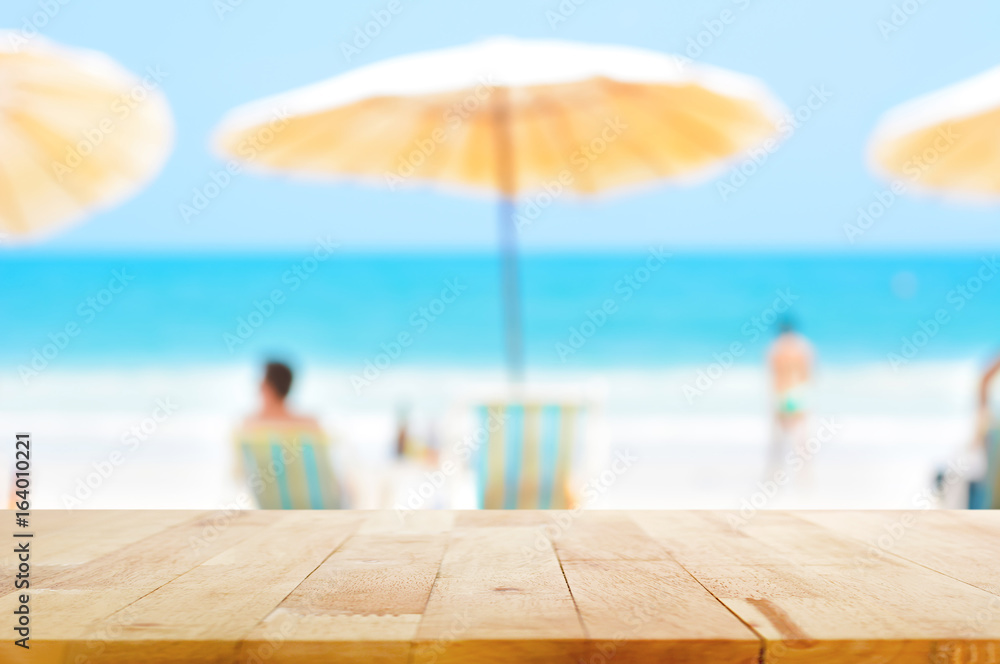 Wood table top on blurred blue sea and white sand beach background with ...