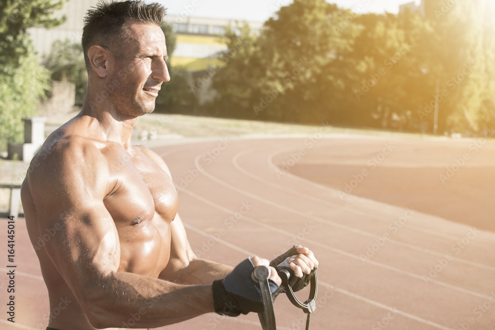 Handsome middle aged man working out on a running track. Healthy adult ...