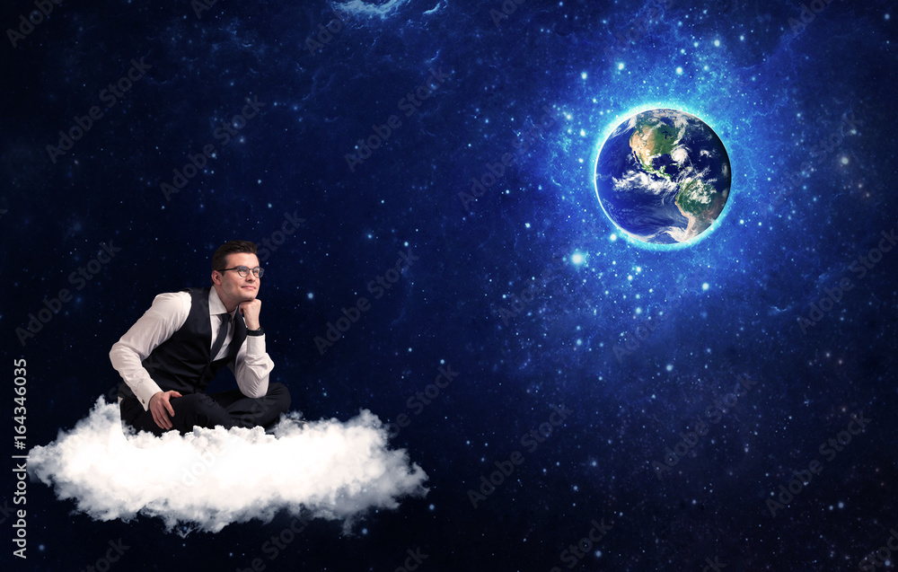 Man sitting on cloud looking at planet earth Stock Photo | Adobe Stock