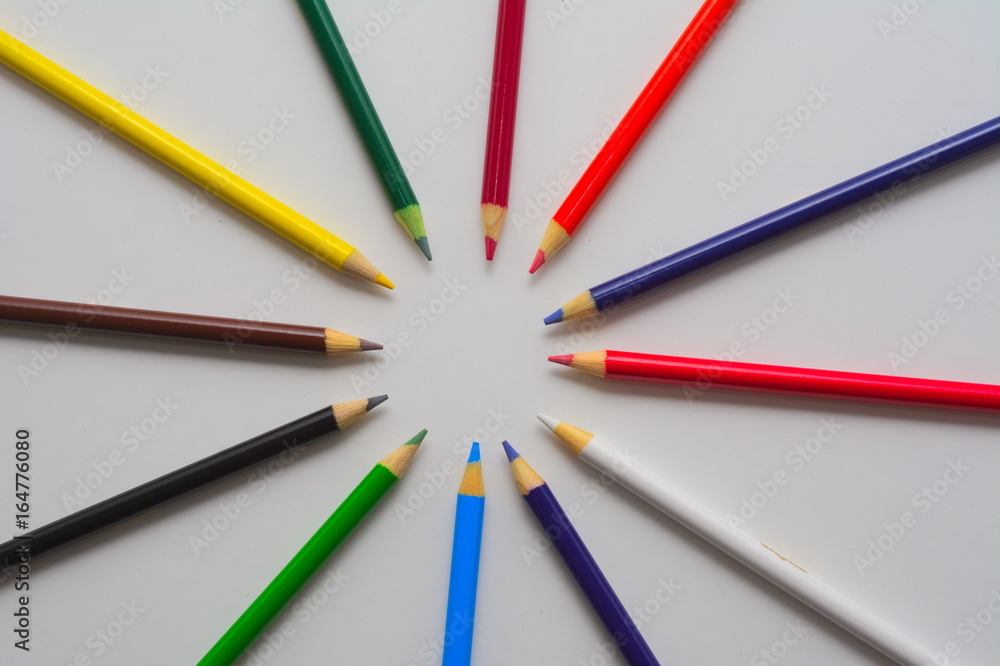 Different colored pencils pointing at each other portraying diversity ...