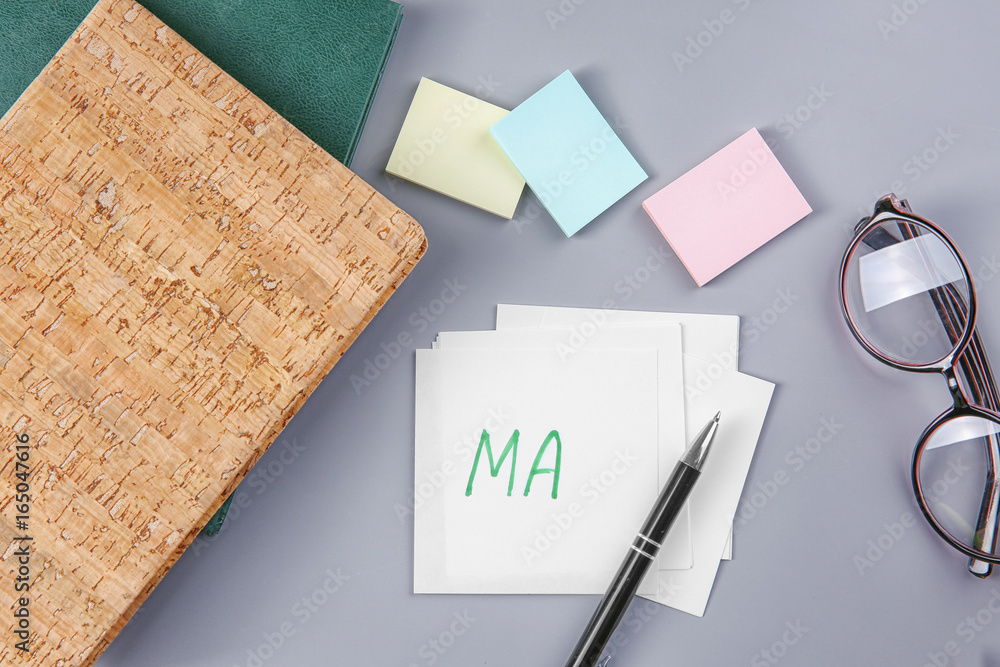 Paper sheets with written text and stationery on grey background ...
