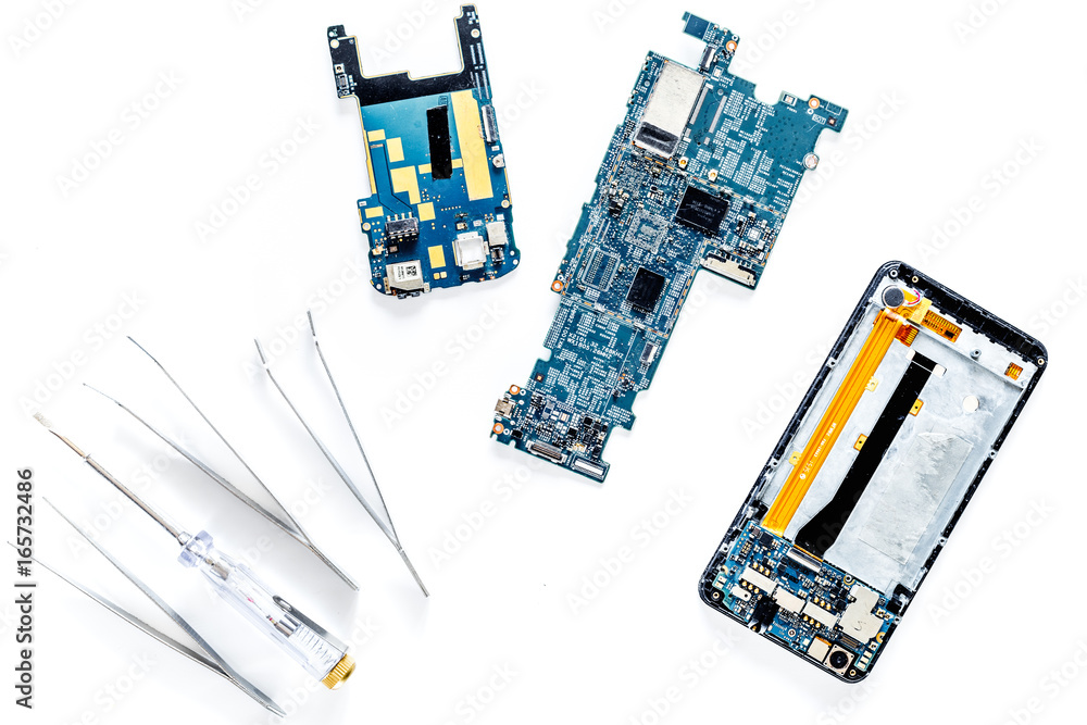 Parts of disassembled cell phone and screwdrivers on white background ...