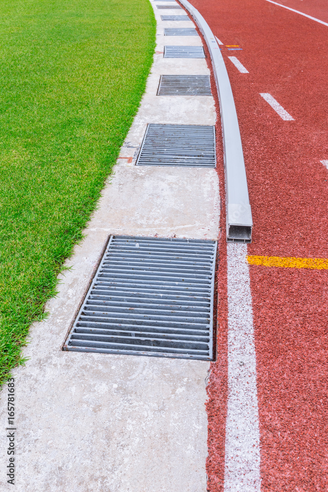 rain drainage in sport stadium - water drain hole around football field ...