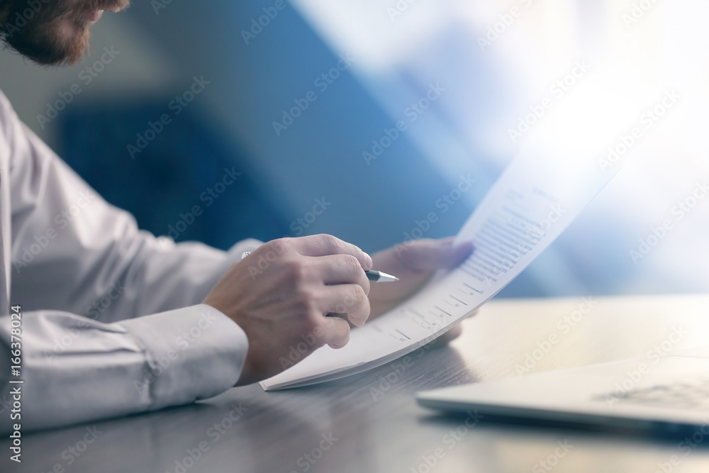 Businessman reading documents Stock Photo | Adobe Stock