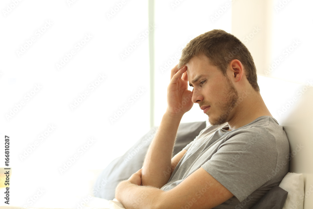 Sad man lamenting on the bed Stock Photo | Adobe Stock