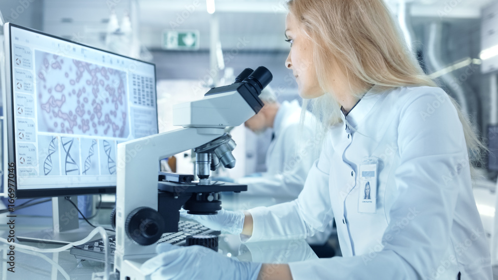 Female Research Scientist Using Electronic Microscope. She and Her ...