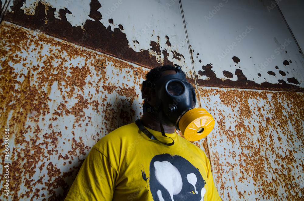 A scary man with reflection eyes in an industrial setting wearing a ...