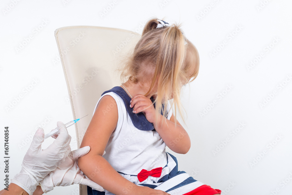 Doctor holds syringe to vaccinate sick baby with injection. Crying and ...