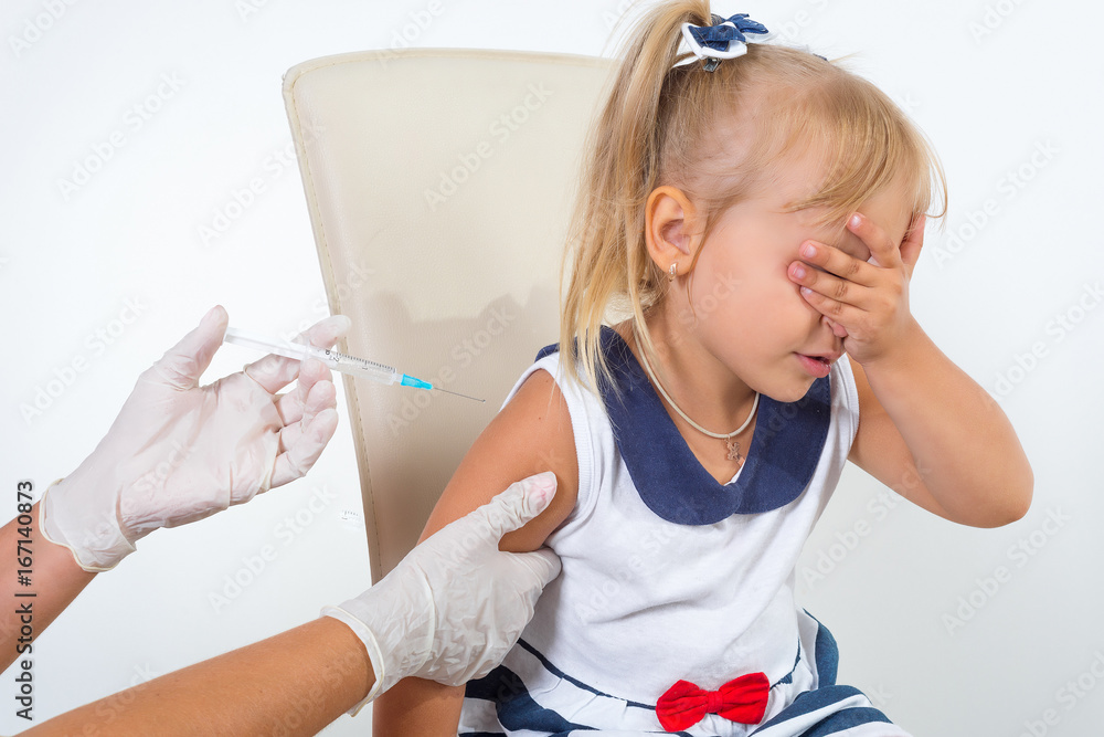 Doctor holds syringe to vaccinate sick baby with injection. Crying and ...