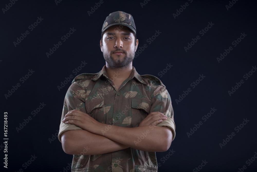 Portrait of a smiling soldier standing with his arms crossed Stock ...