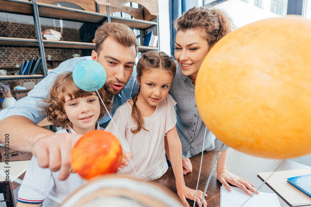 adorable family making solar system model for school project Stock ...