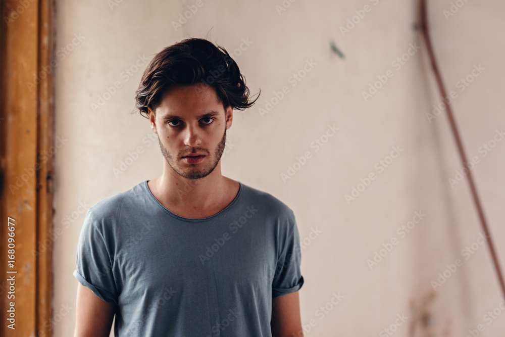 Foto de Stock Nice-looking guy posing like a model with a bold and rude ...