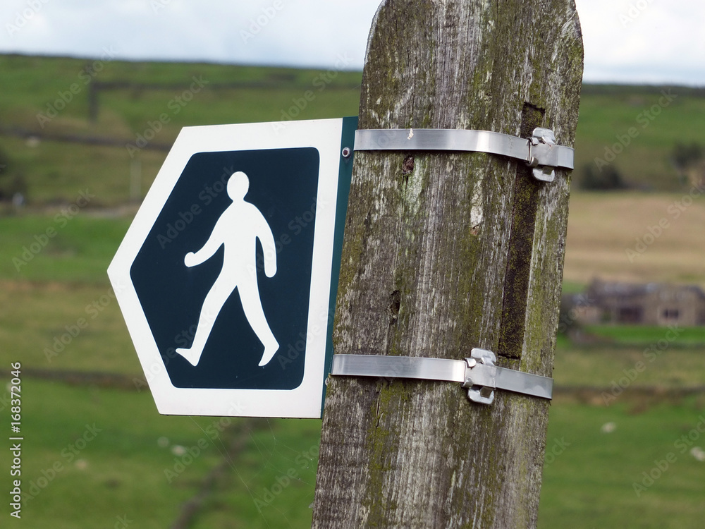 walking direction sign indicating a path or public footpath or right of ...