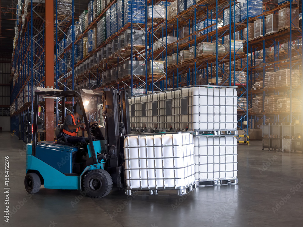 Containers for solvent are handling by forklift to storage in the ...