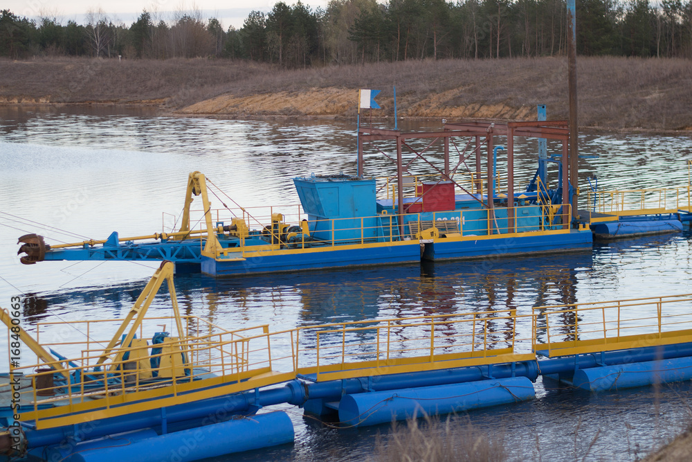 excavation machine at earthmoving work in sand quarry. Extraction of ...