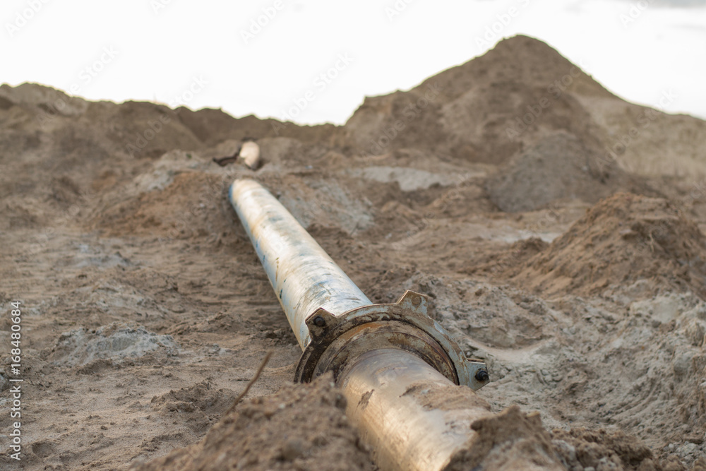 Foto de Stock Steal big pipeline on a sand. Old pipes joint in a desert ...