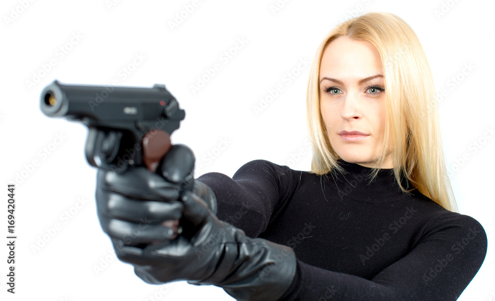 Young blonde woman in a black suit with a gun Stock Photo | Adobe Stock