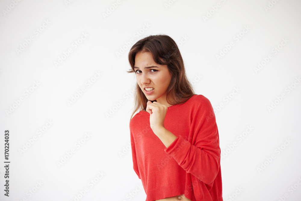 Foto Picture of scared disgusted young Hispanic female looking at ...
