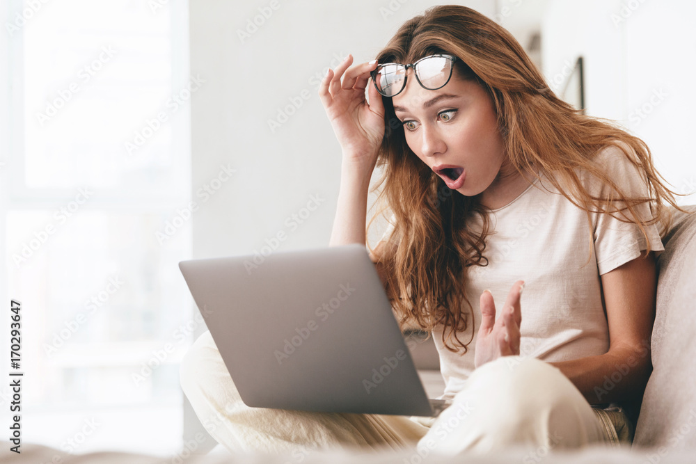 Shocked lady using laptop computer. Stock Photo | Adobe Stock
