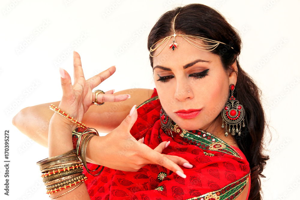 Woman dancing Indian dance in national dress. A handsome beautiful girl ...