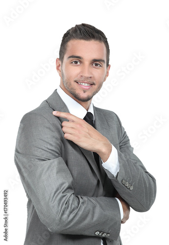 Business man in suit pointing copy space and smiling Stock Photo ...