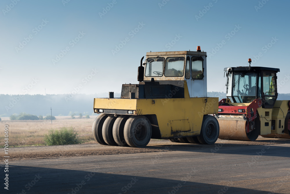 road under construction - wheel loader machine, pneumatic tyred roller ...