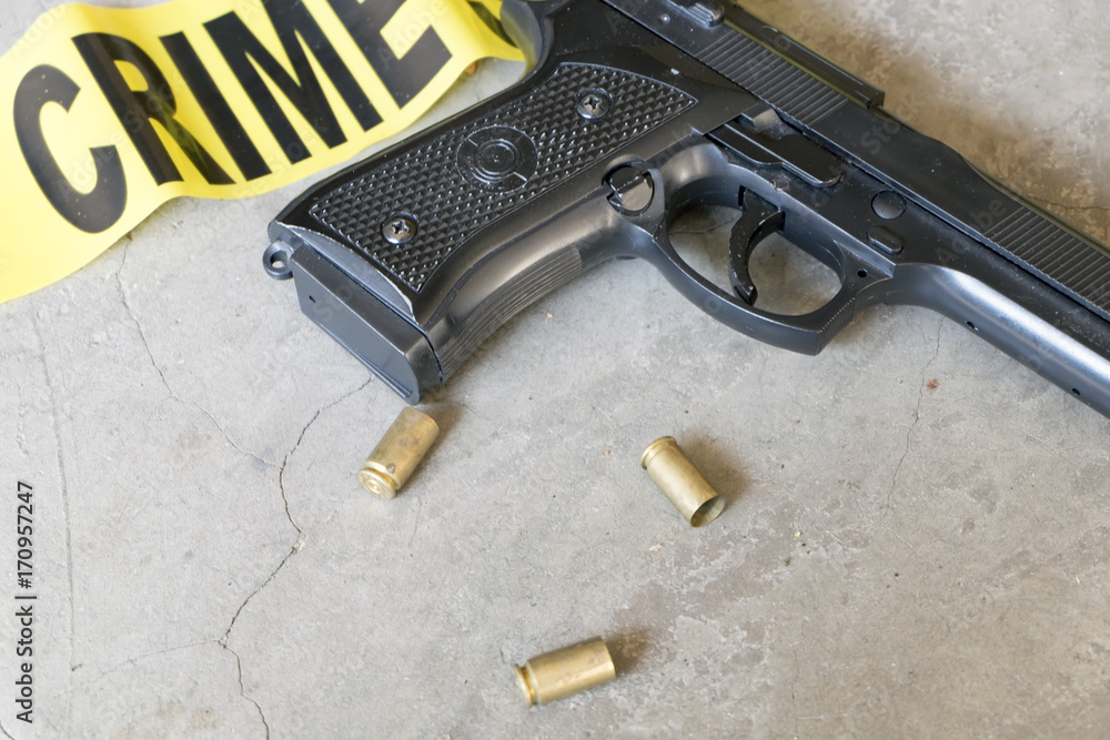 Crime scene concept with gun, crime scene tape and bullet casings Stock ...