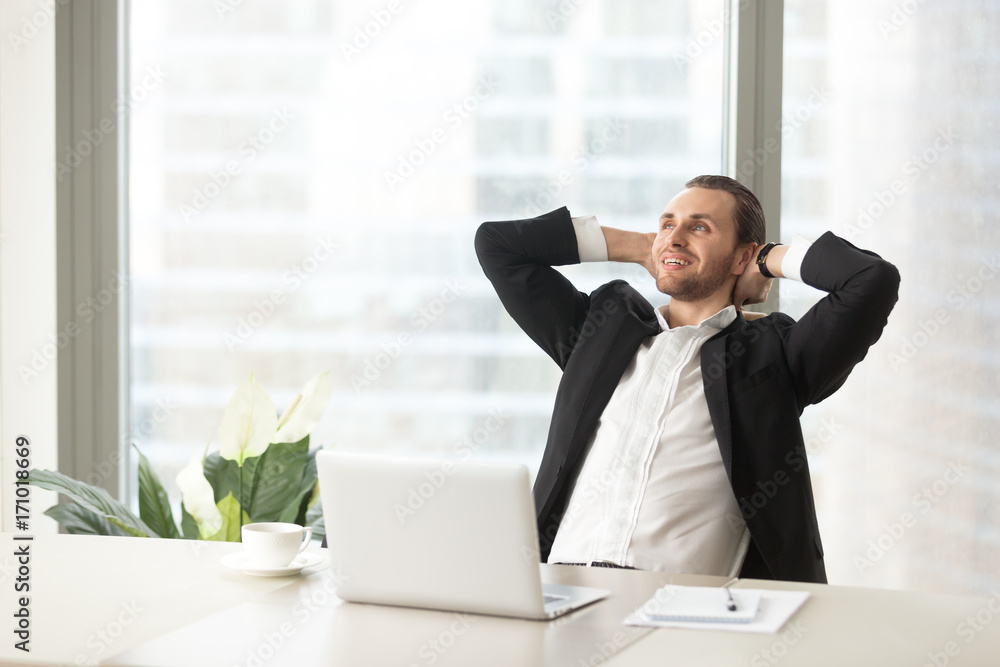 Photo Stock Happy smiling businessman relaxing, stretching his back ...