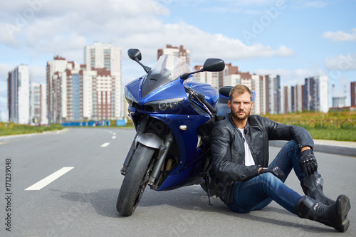 Attractive brutal unshaven young biker man wearing leather jacket ...