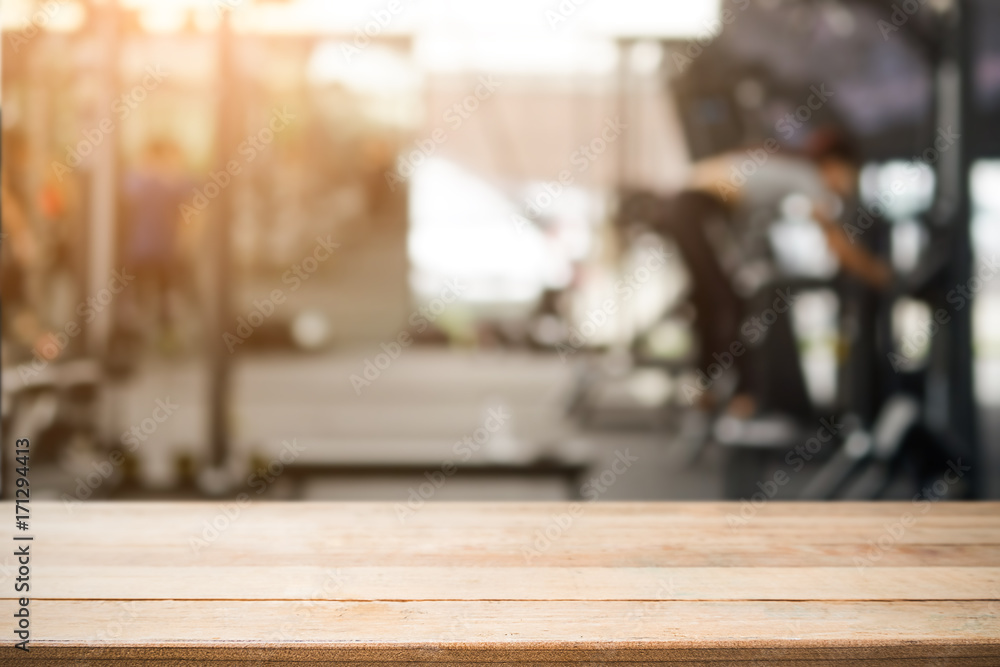 fitness gym and wooden table with copy space. Stock Photo | Adobe Stock