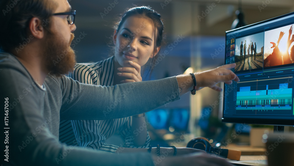 Female and Male Video Editors Work With Footage and Sound on Their ...