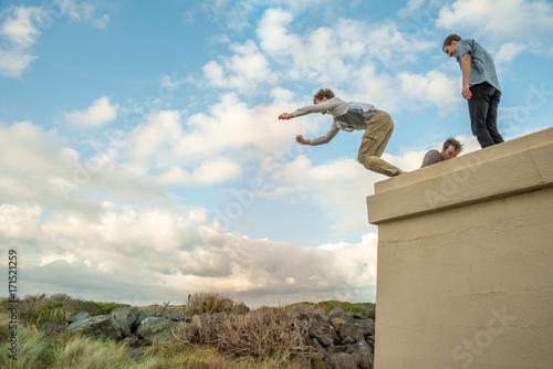 Outdoor adventures of young men; jumping off building, having fun Stock ...