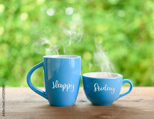 Blue Coffee cups and Happy Friday Quote on nature green blurred ...