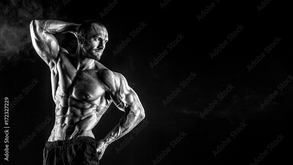 Strong bald bodybuilder with six pack. Strong bodybuilder man with ...