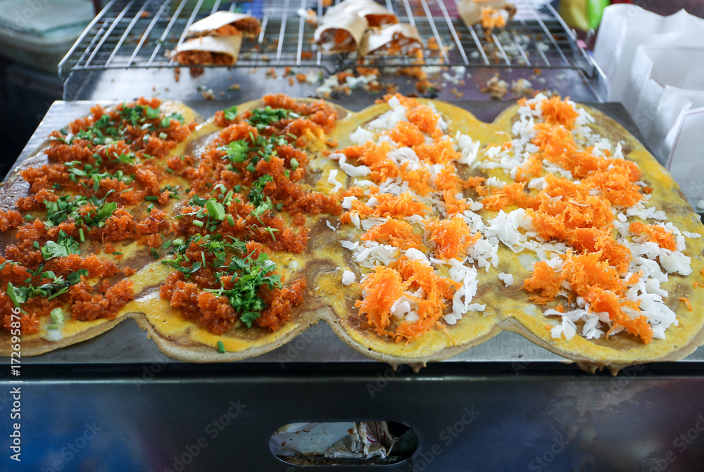 Thai crepe with toppings, golden egg yolk thread and shrimp, Khanom ...