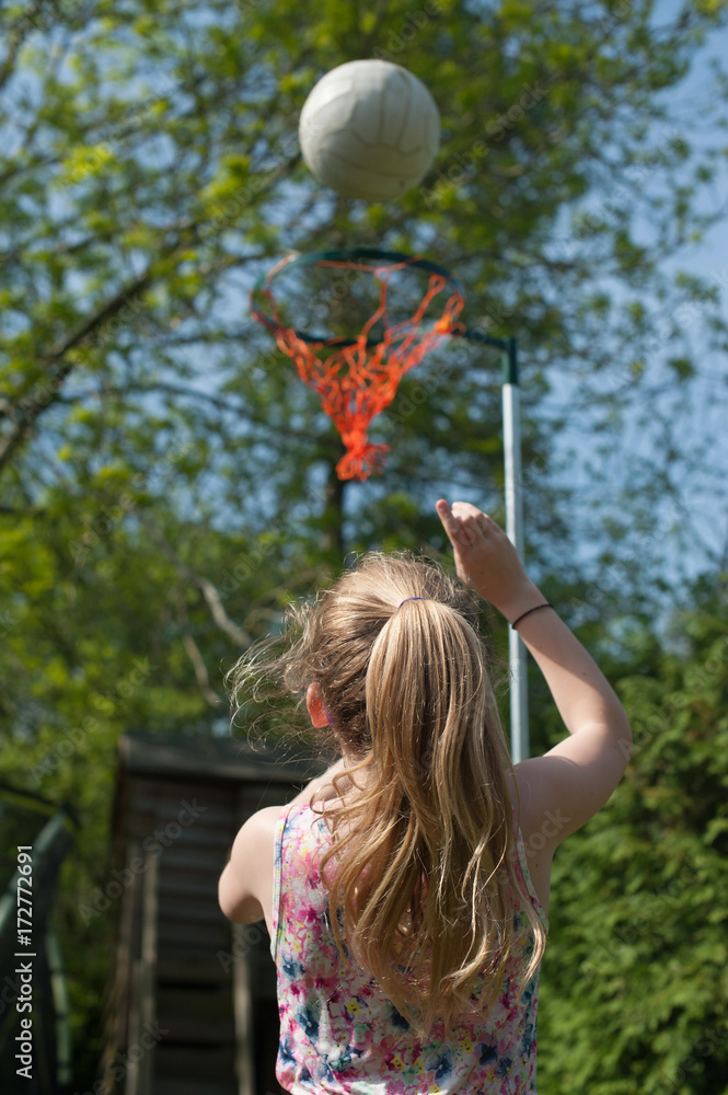 Young girl playing netball Stock Photo | Adobe Stock