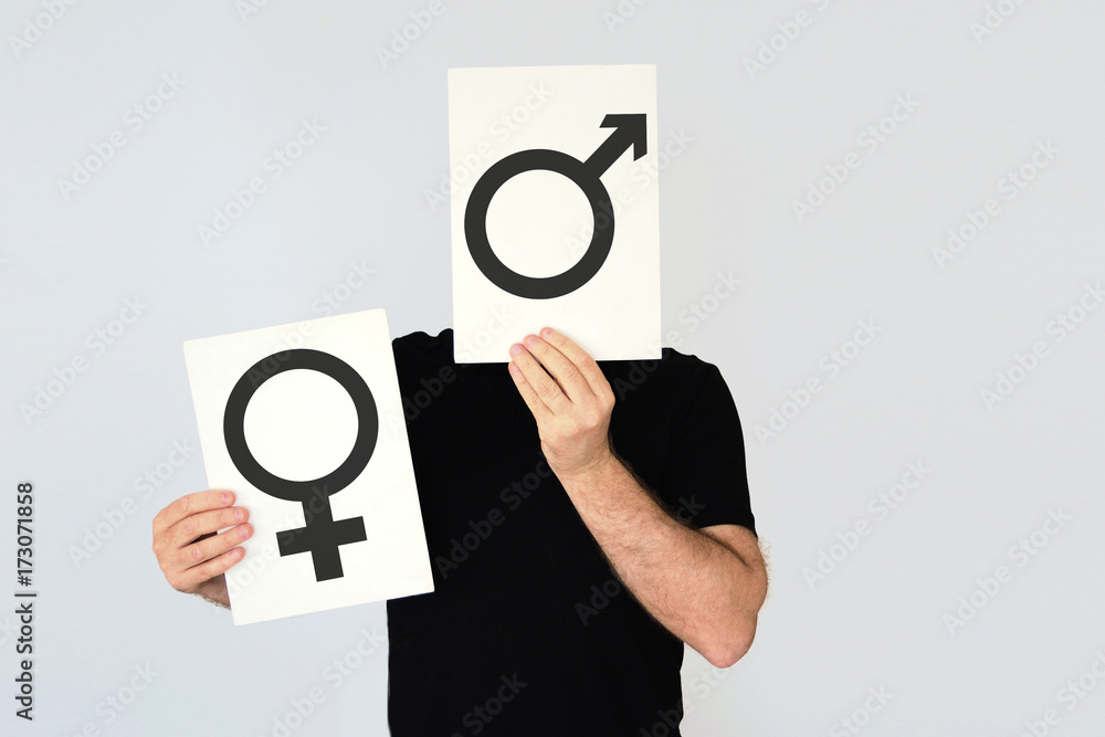 Man holding two cards with the MALE and FEMALE symbols representing ...