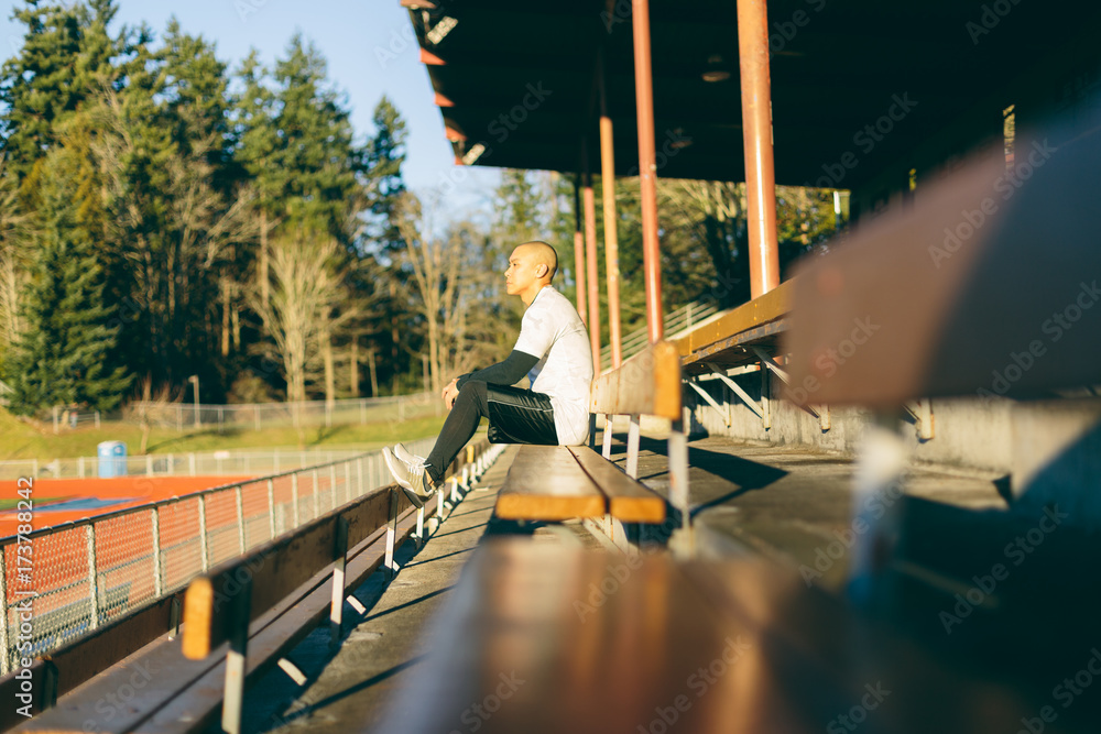 Athletic Man Sitting On Bleachers At Track And Field Stadium Stock ...