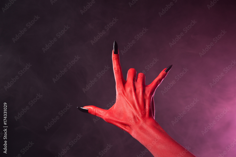 Red devil hand with black nails showing heavy metal symbol Stock Photo ...