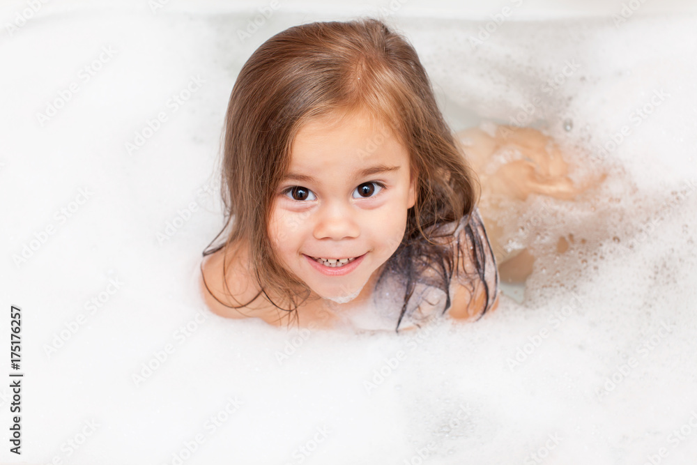 Happy little child girl is taking a bath with a foam Stock Photo ...