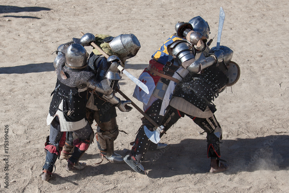 Men in a medieval battle. They are protected by armors from the 14th ...