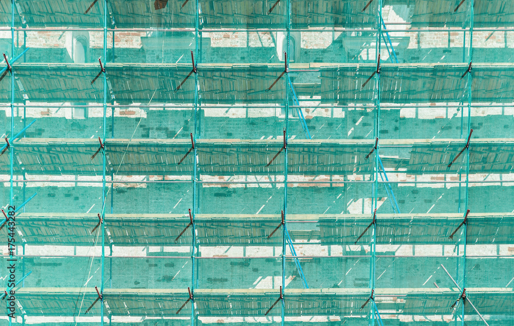 Scaffolding in difference levels with green transparency covering net ...