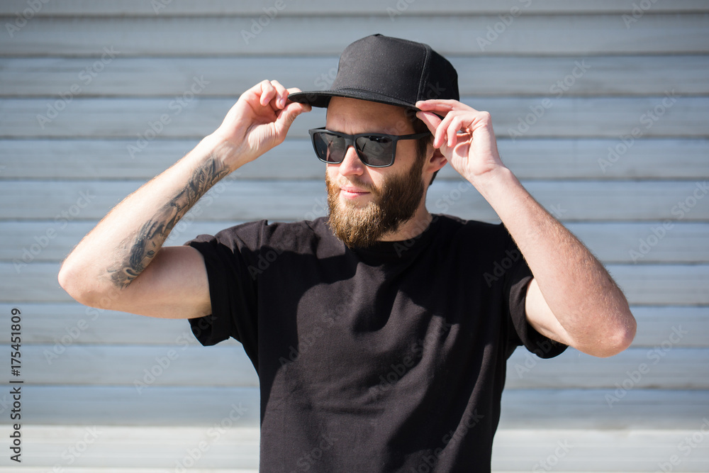 Hipster handsome male model with beard wearing black blank baseball cap ...